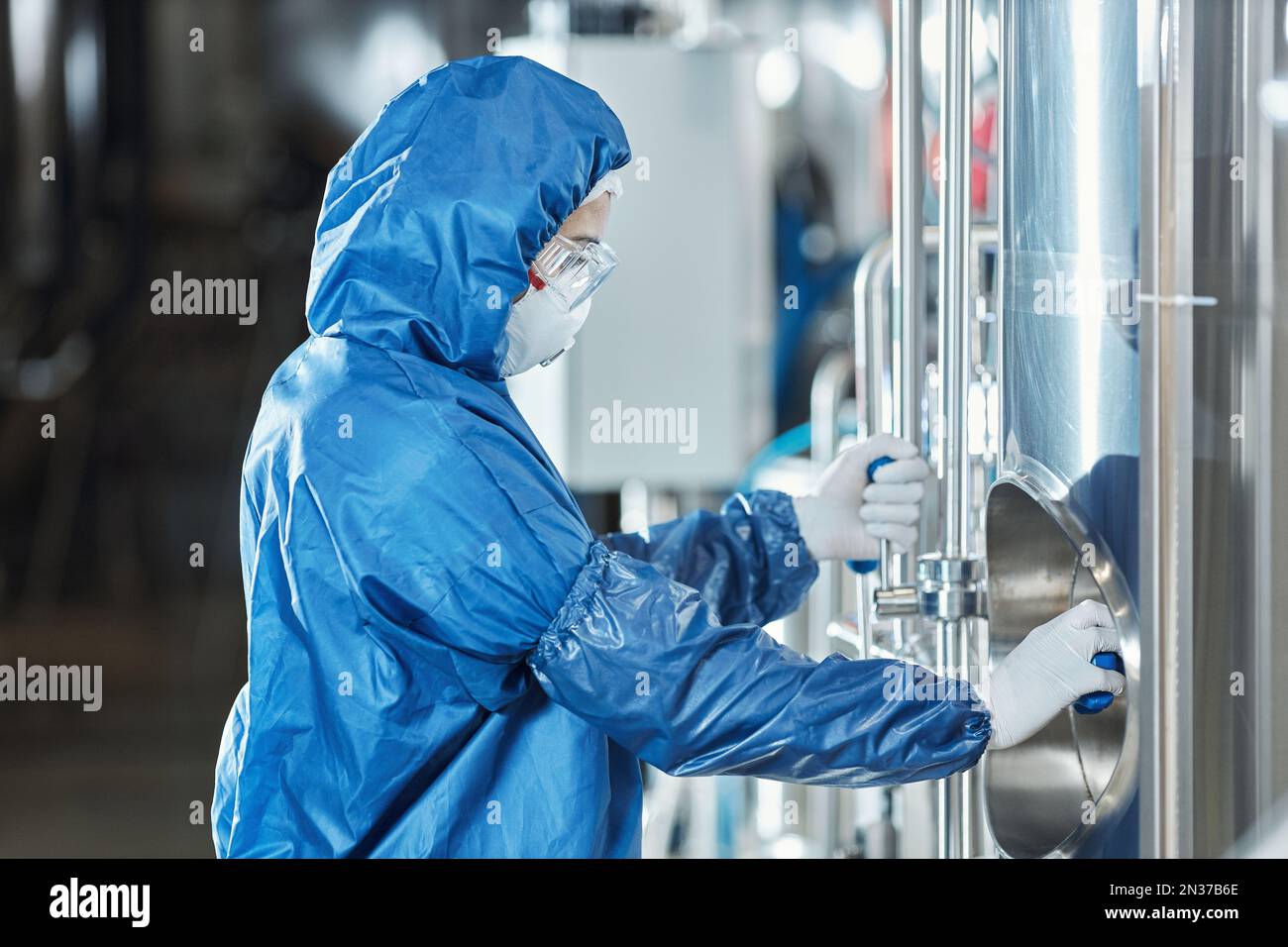 Side view portrait of female worker wearing protective gear while ...