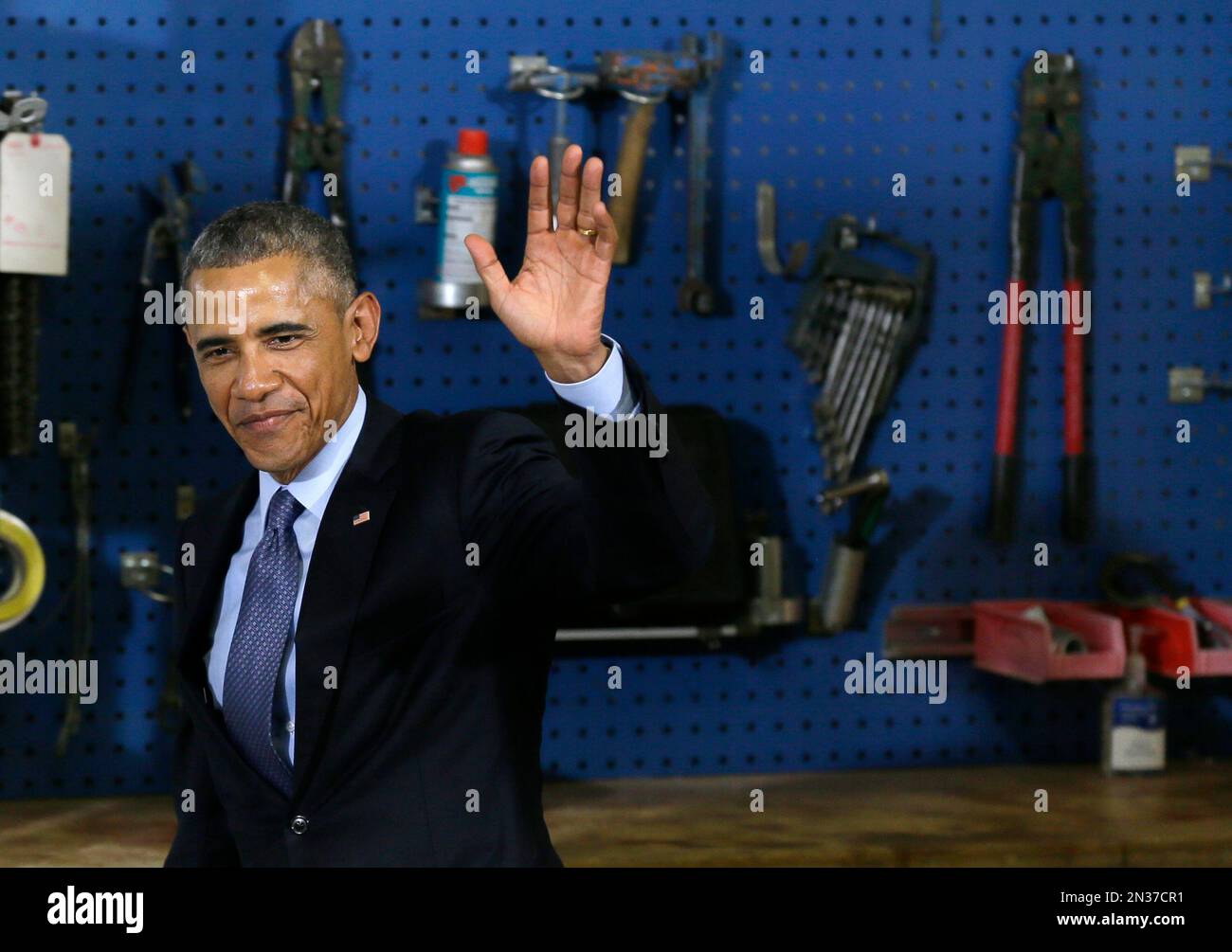 President Barack Obama waves as he arrives to speak at Cedar Falls ...