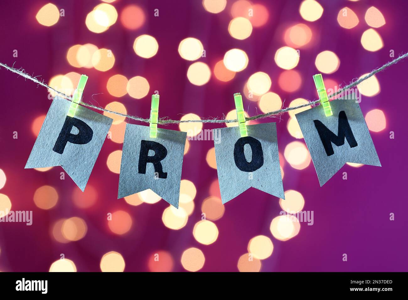 Rope with clothespins and word PROM against blurred lights Stock Photo ...