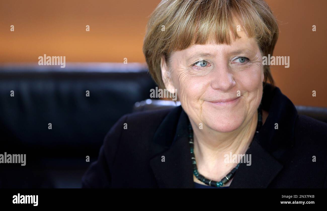 German Chancellor Angela Merkel smiles as she arrives for the weekly ...