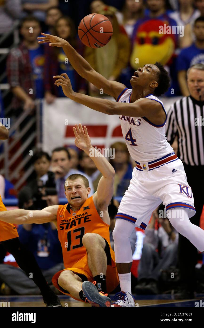 Kansas guard Devonte Graham (4) and Oklahoma State guard Phil Forte III ...
