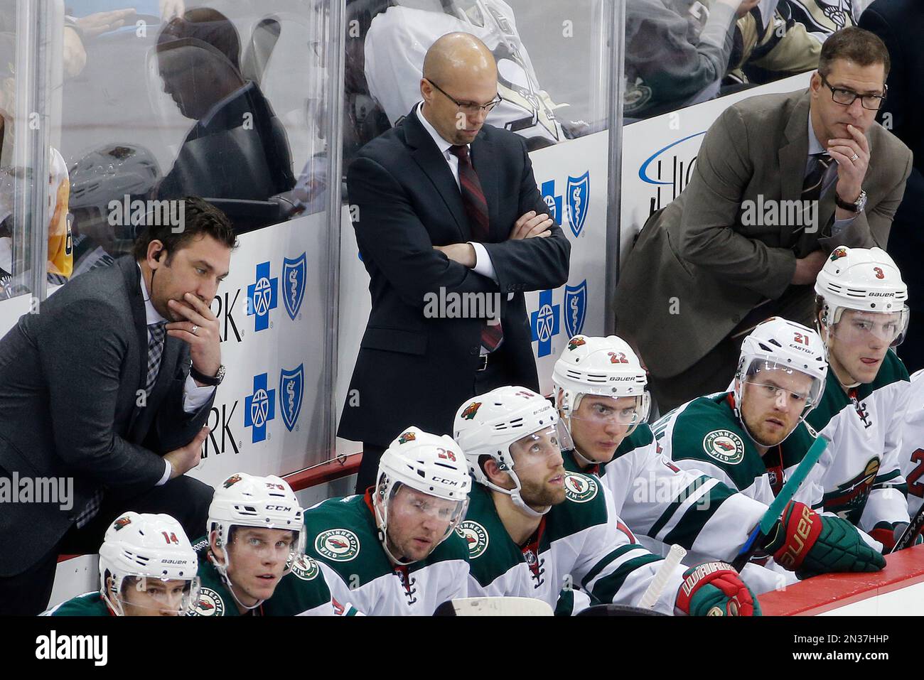 Minnesota Wild head coach Mike Yeo, center, is flanked by assistants ...