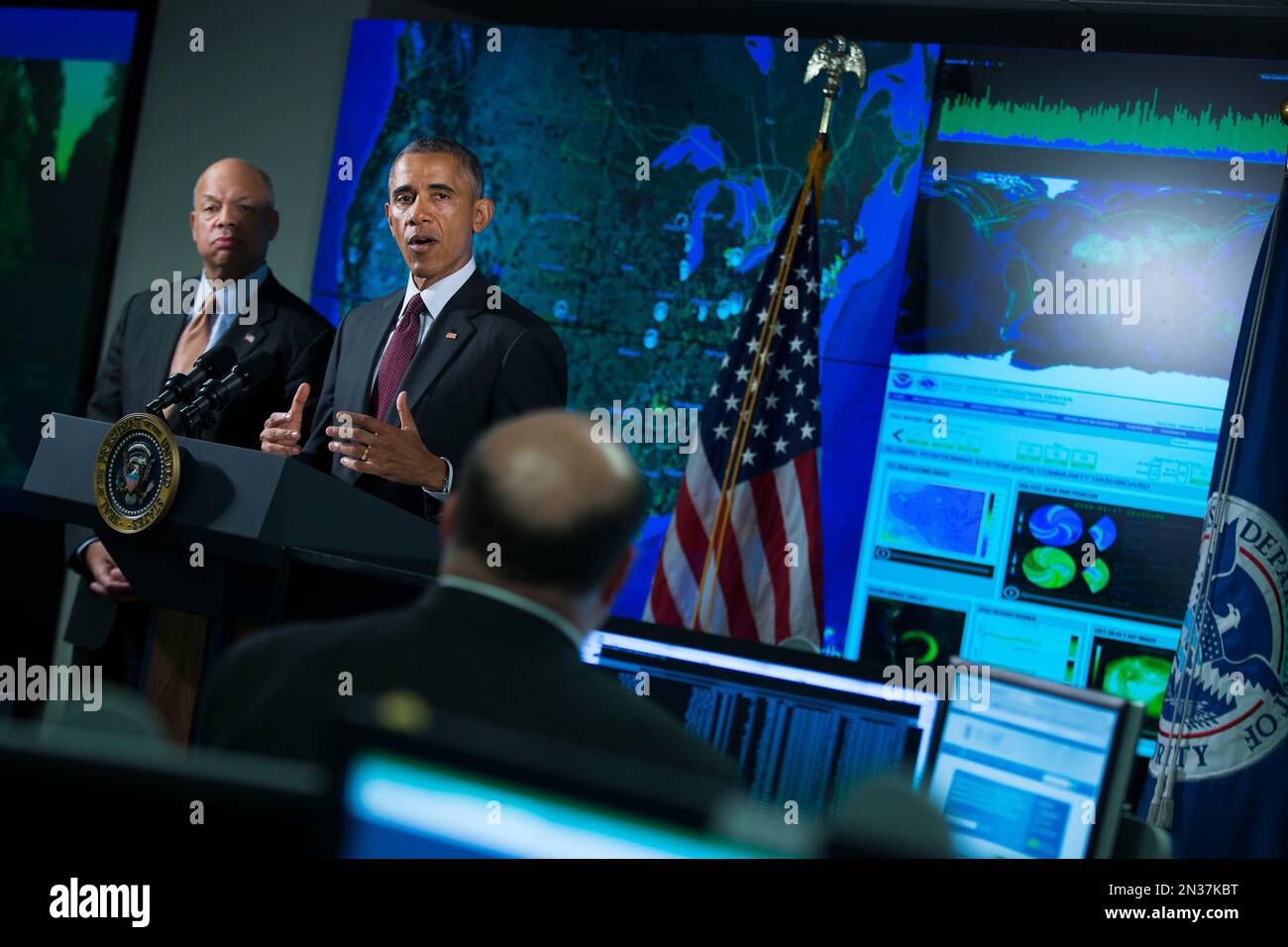 Homeland Security Secretary Jeh Johnson listens at left as President ...