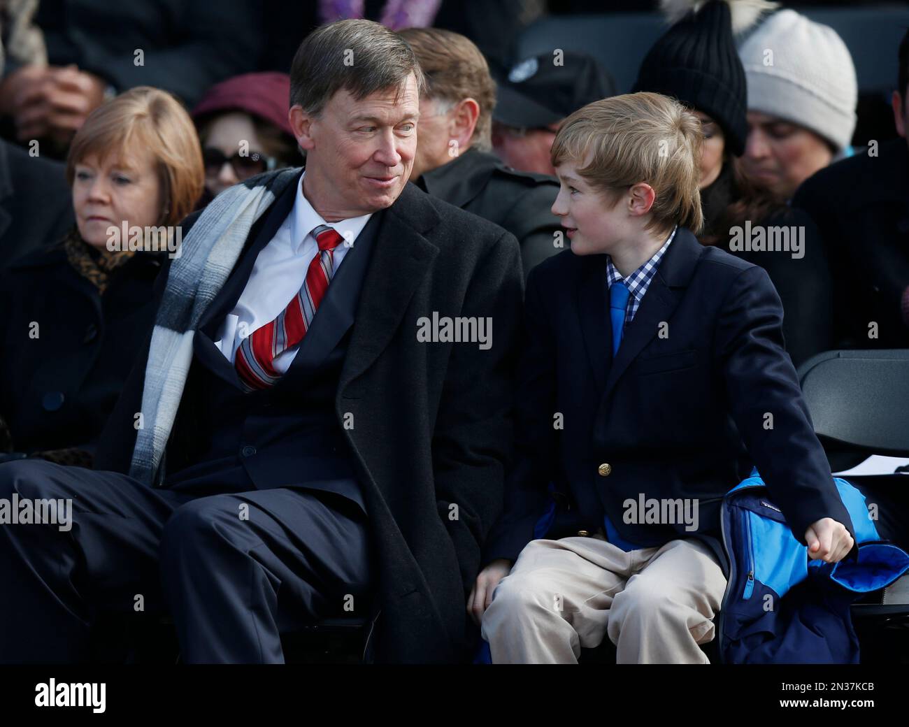 Colorado Gov. John Hickenlooper, left confers with hsi 12-year-old son ...