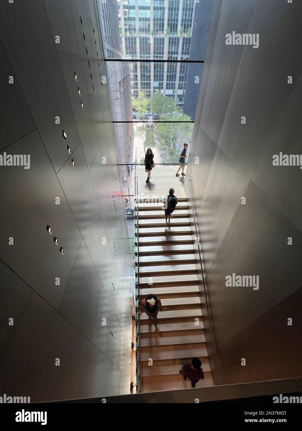 Looking down a large window lit stairway at the Museum of Modern Art in ...