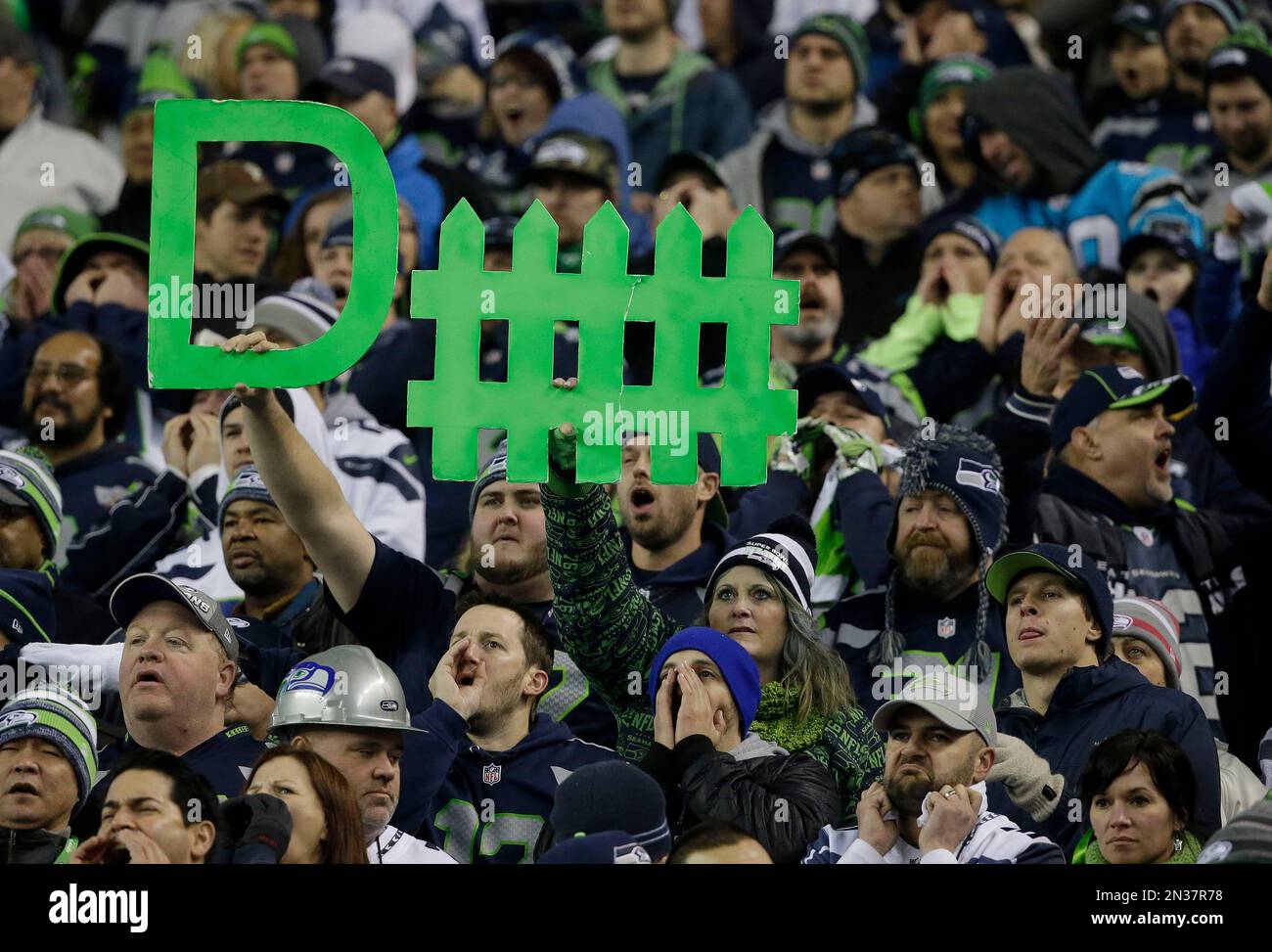 Fans hold up signs for the Seattle Seahawks defense during the second ...