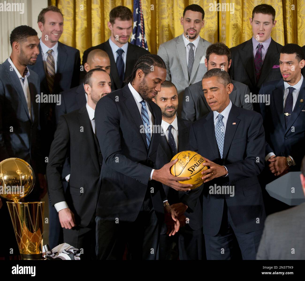 President Barack Obama is presented an autographed basket by San ...