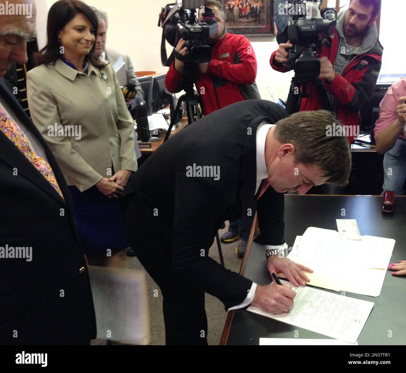 Democratic Attorney General Jack Conway signs the papers for his name ...