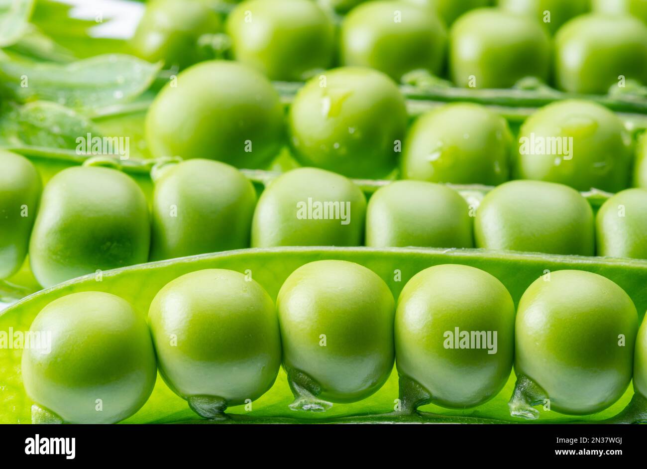 Perfect green peas in pea pods close up. Food background Stock Photo ...