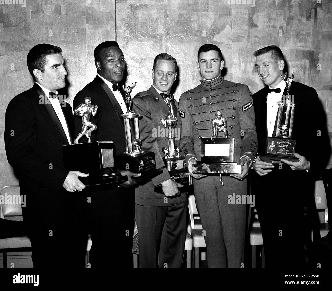 Footballers honored by the Touchdown Club of Washington stand with ...