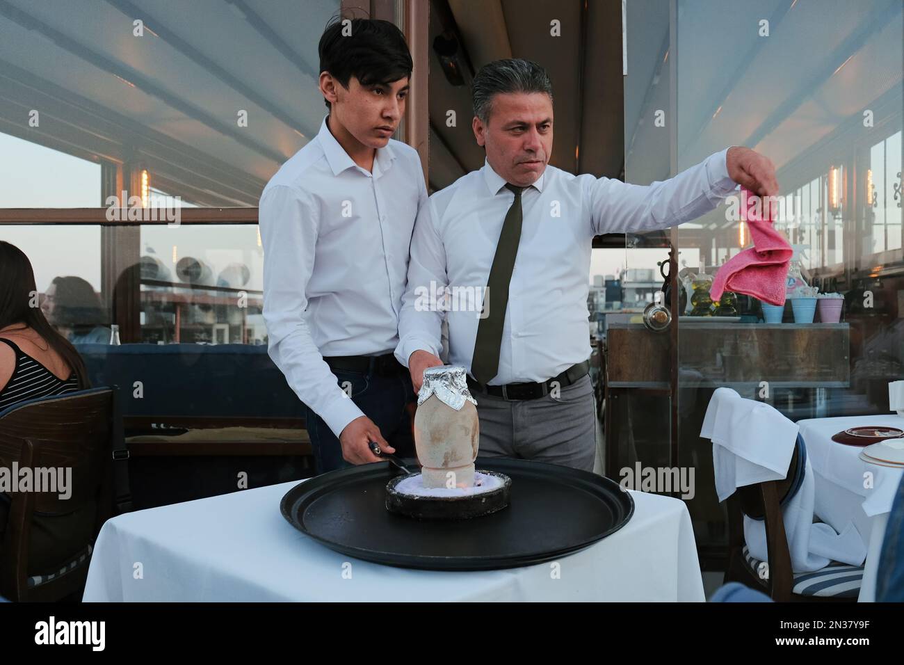 Chef preparing the Turkish national dish, Testi Kebab, in the pot that ...