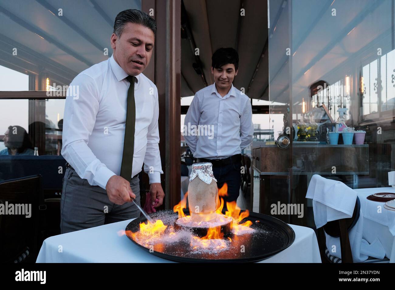 Chef preparing the Turkish national dish, Testi Kebab, in the pot that ...