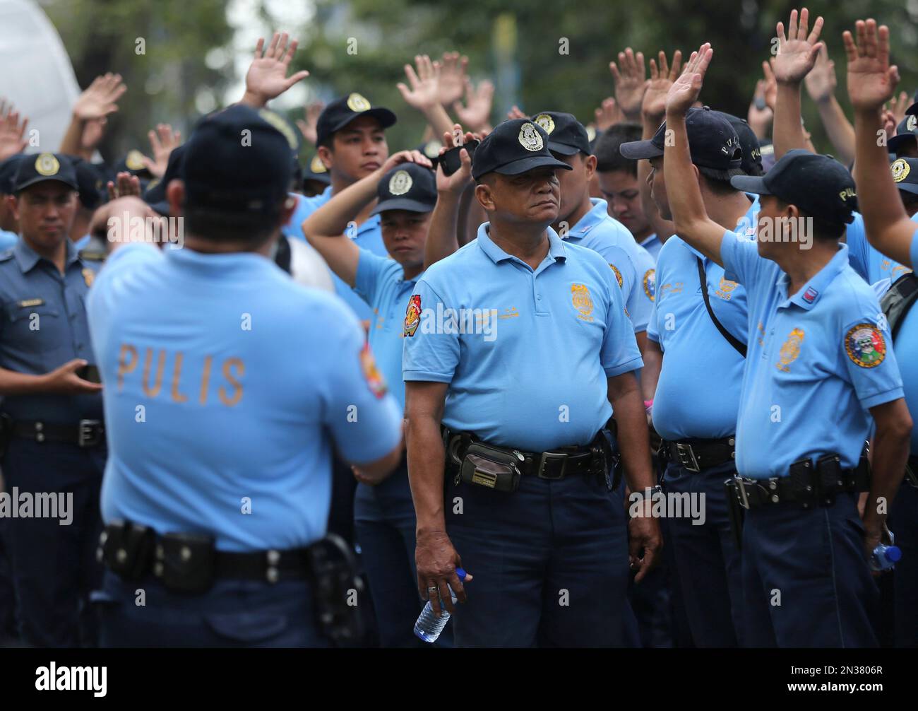 Filipino policemen raise their hands during security preparations for ...