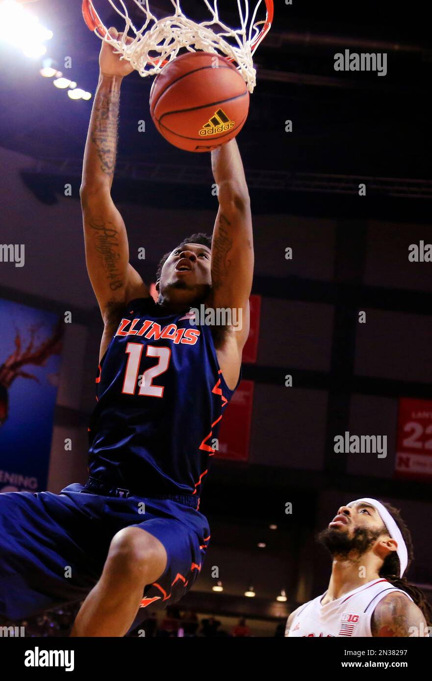 Illinois' Leron Black (12) dunks as Nebraska's Terran Petteway (5 ...