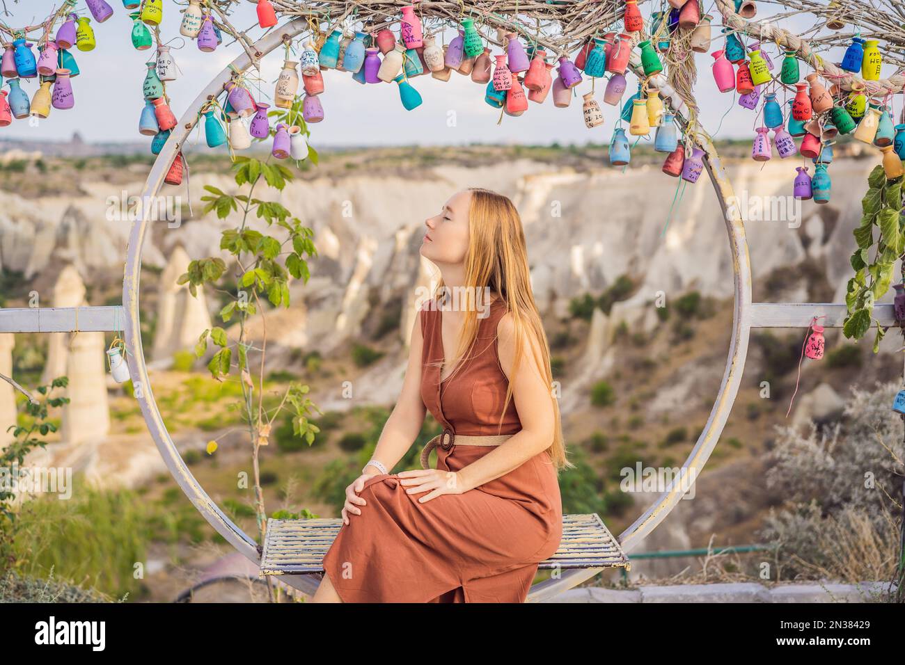 Young woman exploring valley with rock formations and fairy caves near ...