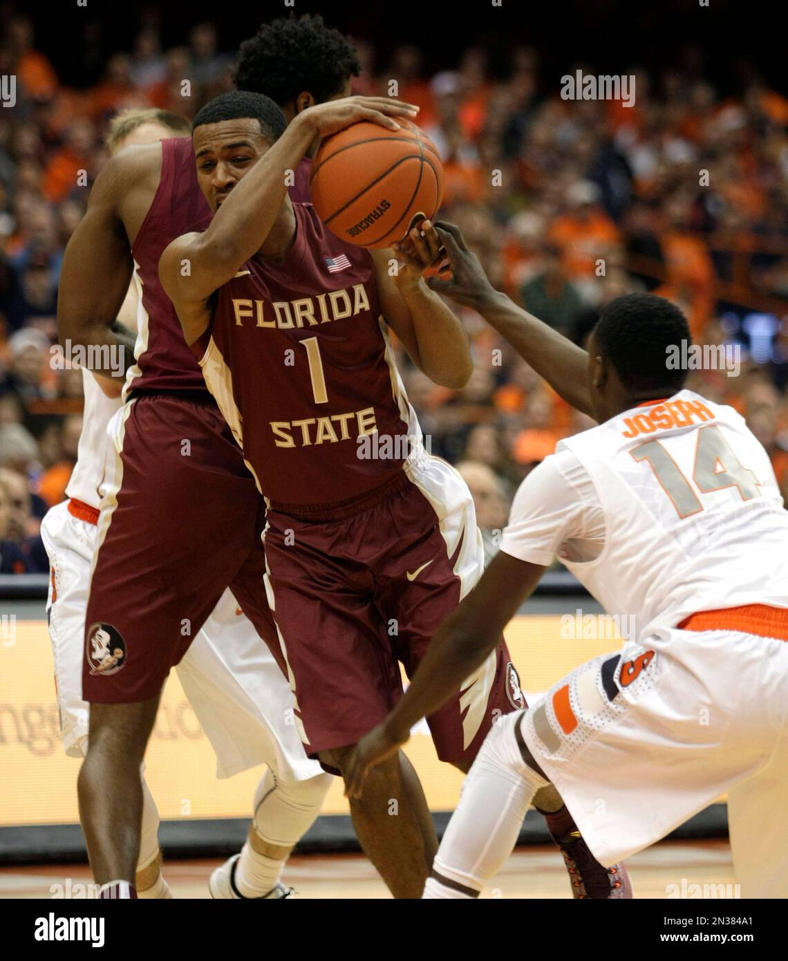 Florida State’s Devon Bookert, center, drives past Syracuse’s Kaleb ...