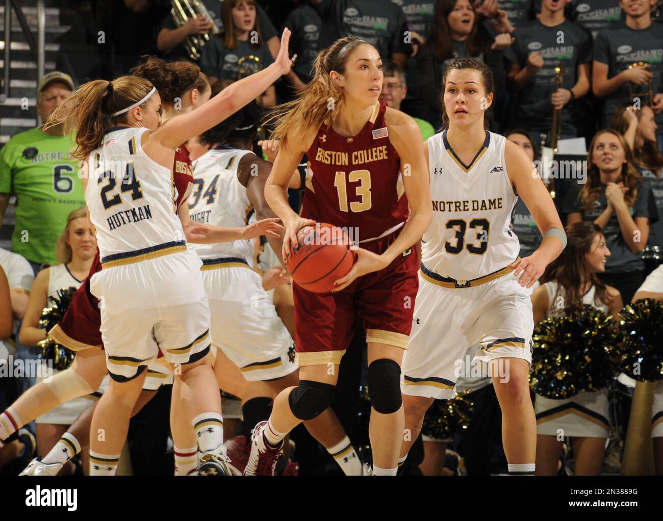 Boston College forward Alexa Coulombe throws a pass between Notre Dame guard Hannah Huffman and ...