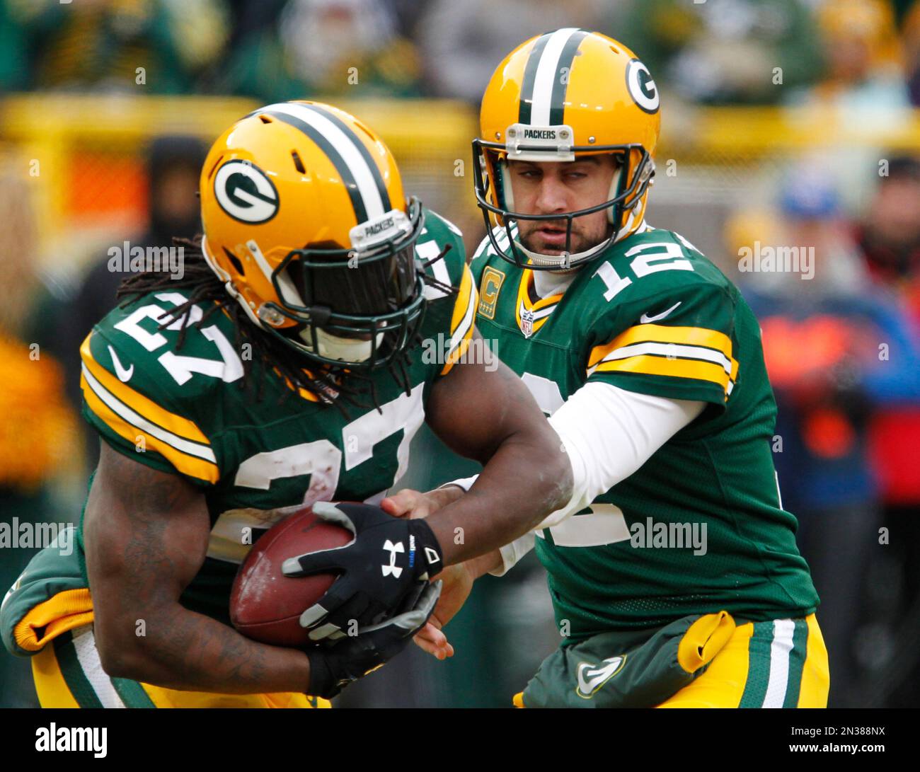 Green Bay Packers quarterback Aaron Rodgers hands the ball off to ...