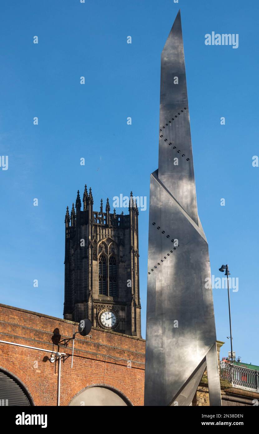 Modern sculpture and clock tower of Manchester Cathedral UK Stock Photo ...