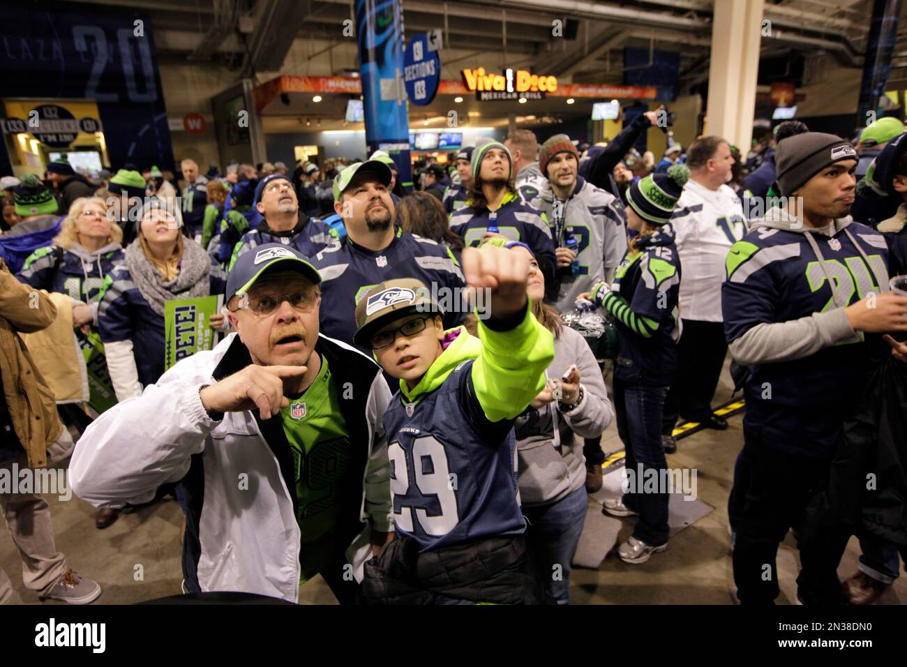 Seattle Seahawks fans watch a video screen outside of CenturyLink Field ...