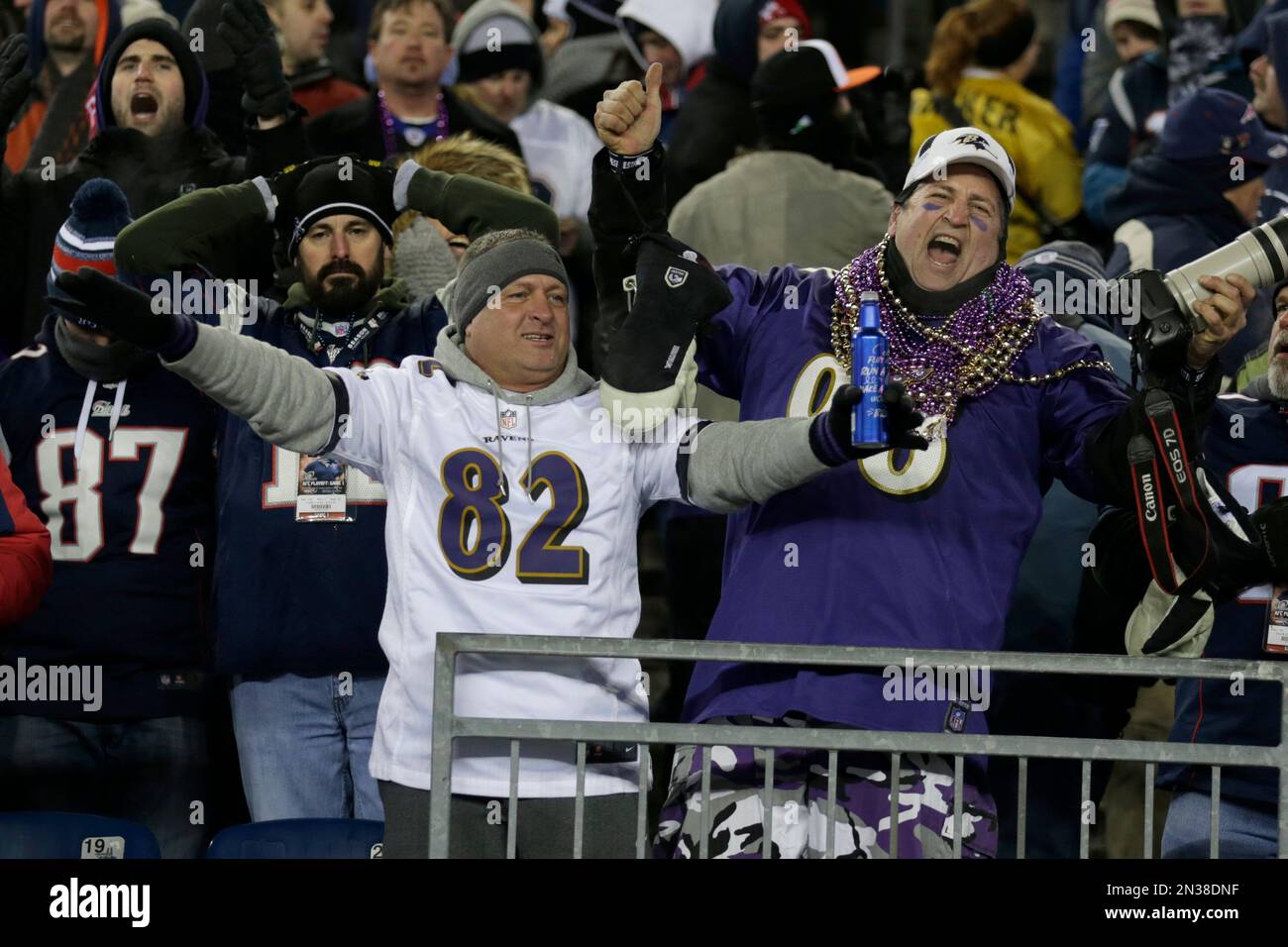 Baltimore Ravens fans celebrate amid New England Patriots fans in the ...