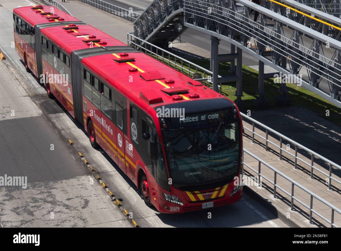 BOGOTA, COLOMBIA - Three wagon transmilenio red bus near to a peatonal ...