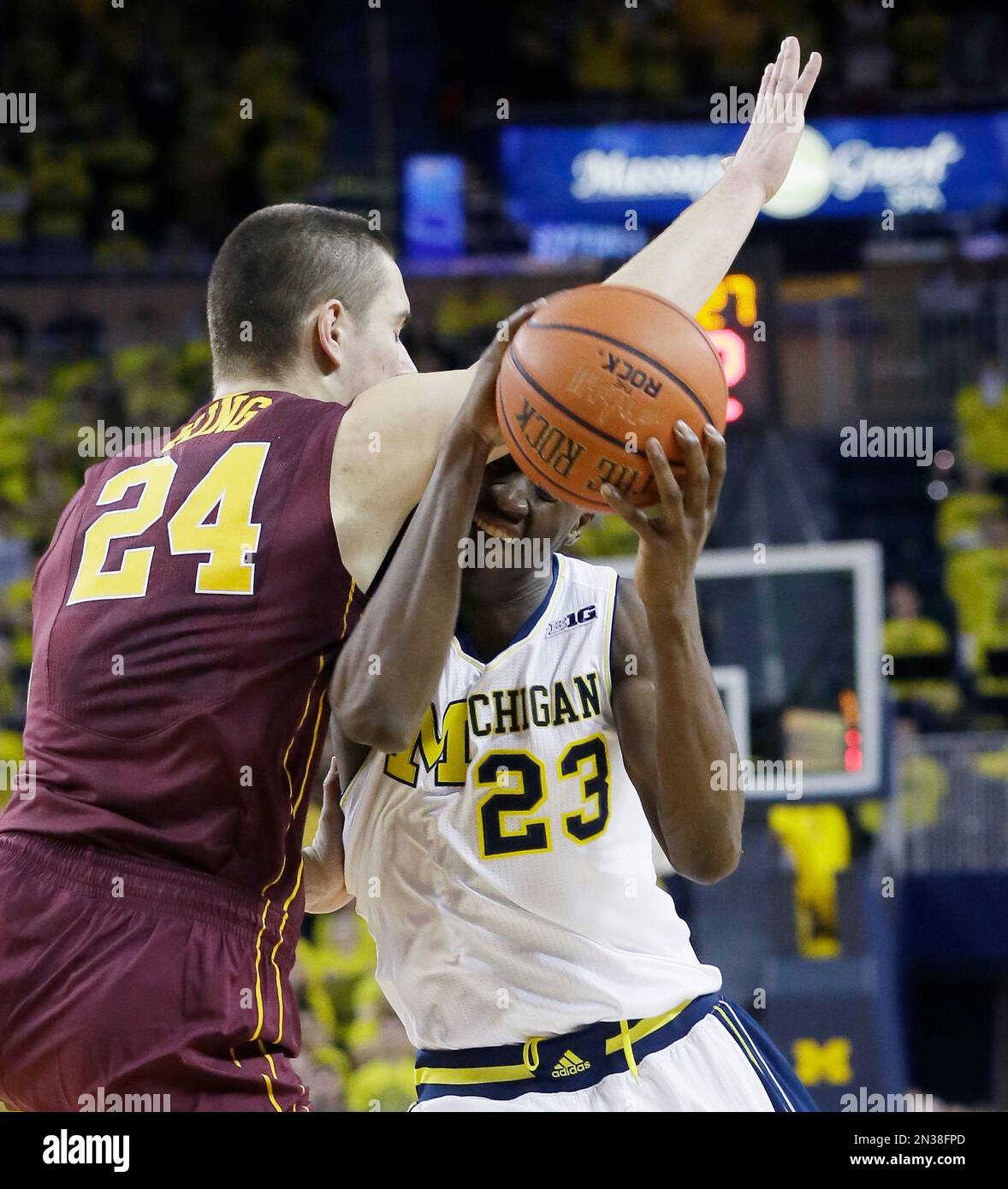 Michigan guard Caris LeVert (23) is fouled by Minnesota forward Joey ...
