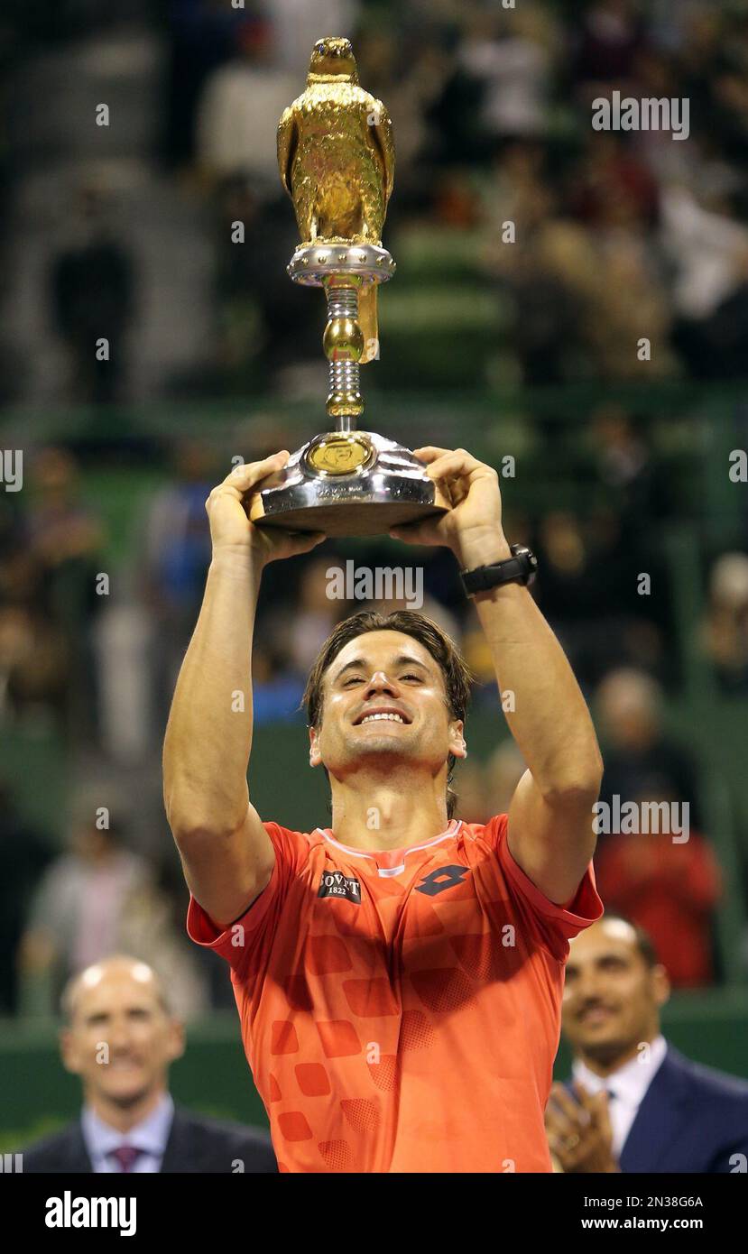 Spain's David Ferrer poses with his trophy after winning the Qatar's ...