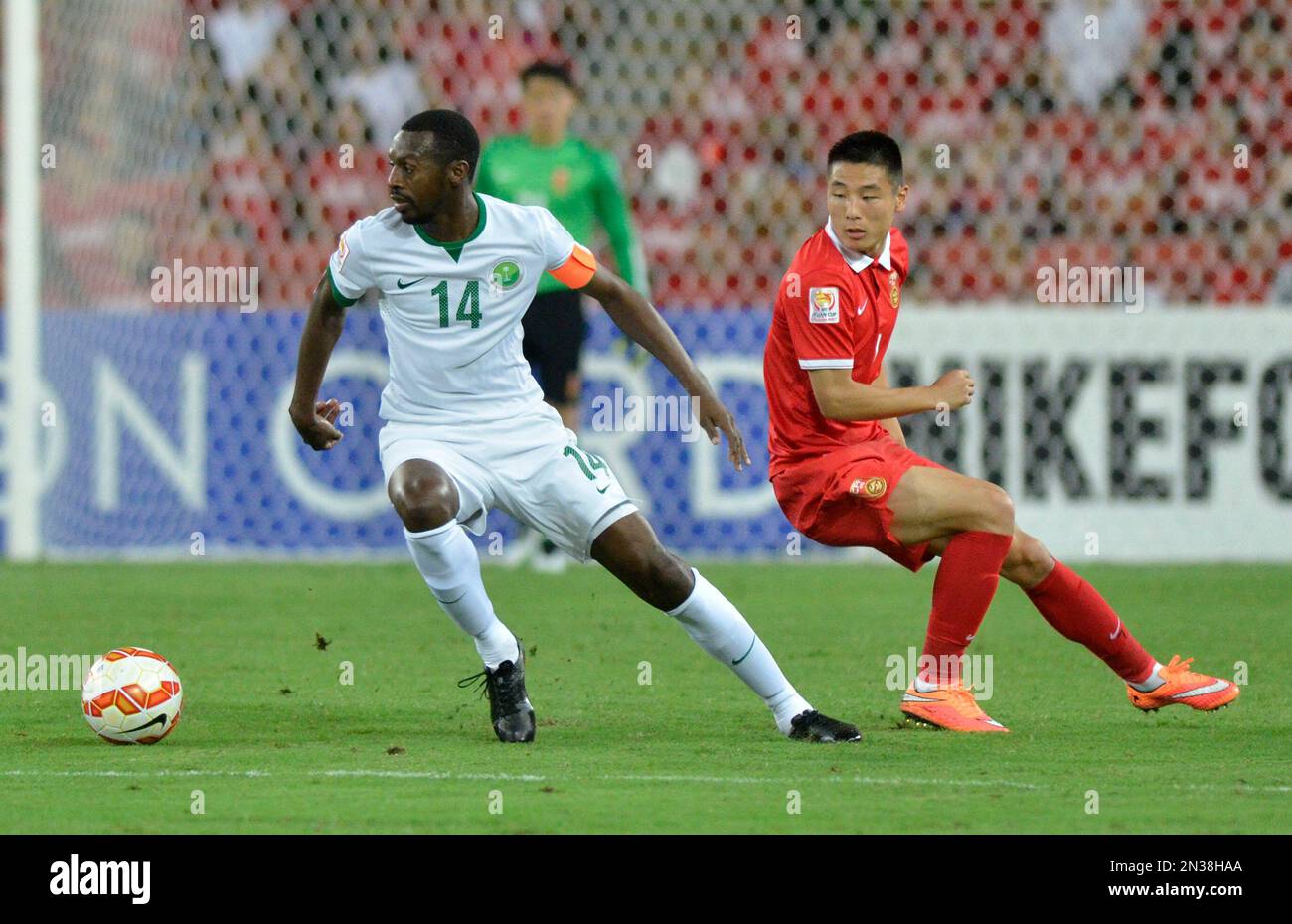 Saudi Arabia's Saud Kariri left, takes the ball away from China's Wu ...