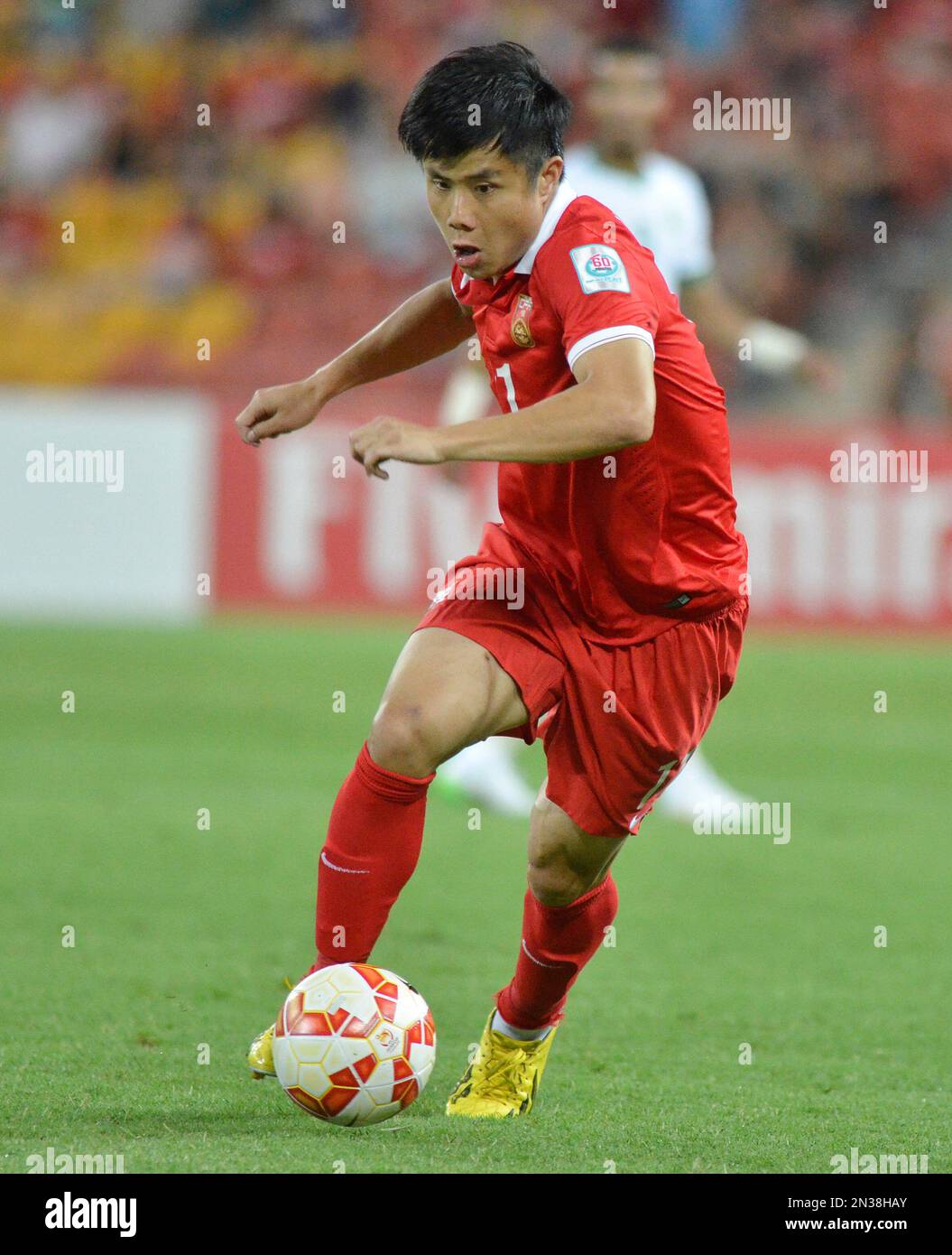 China's Hao Junmin takes the ball upfield during the first round soccer match of the AFC Asia ...