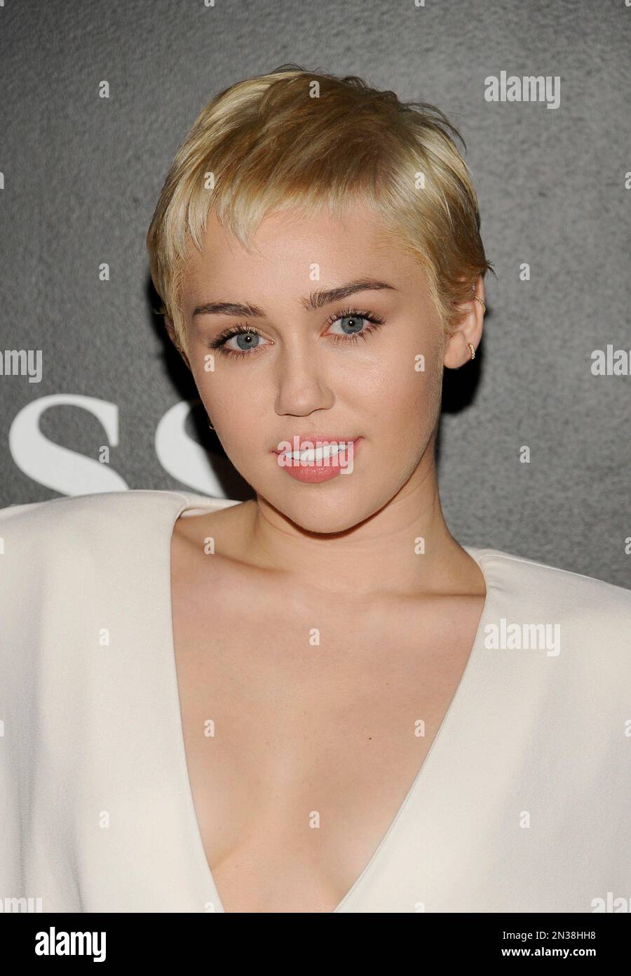 Event co-host Miley Cyrus poses at the opening of W Magazine's ...
