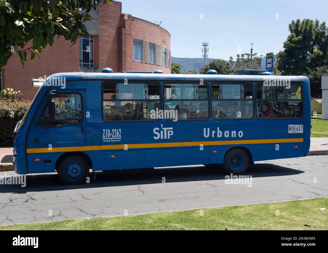BOGOTA, COLOMBIA - Blue SITP small bus picking up a passengers in sunny ...