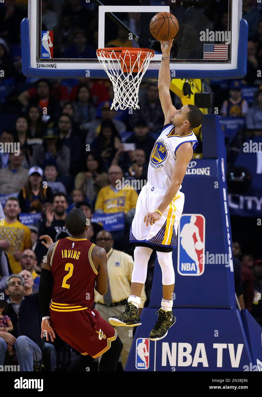 Golden State Warriors' Stephen Curry, top, lays up a shot over ...