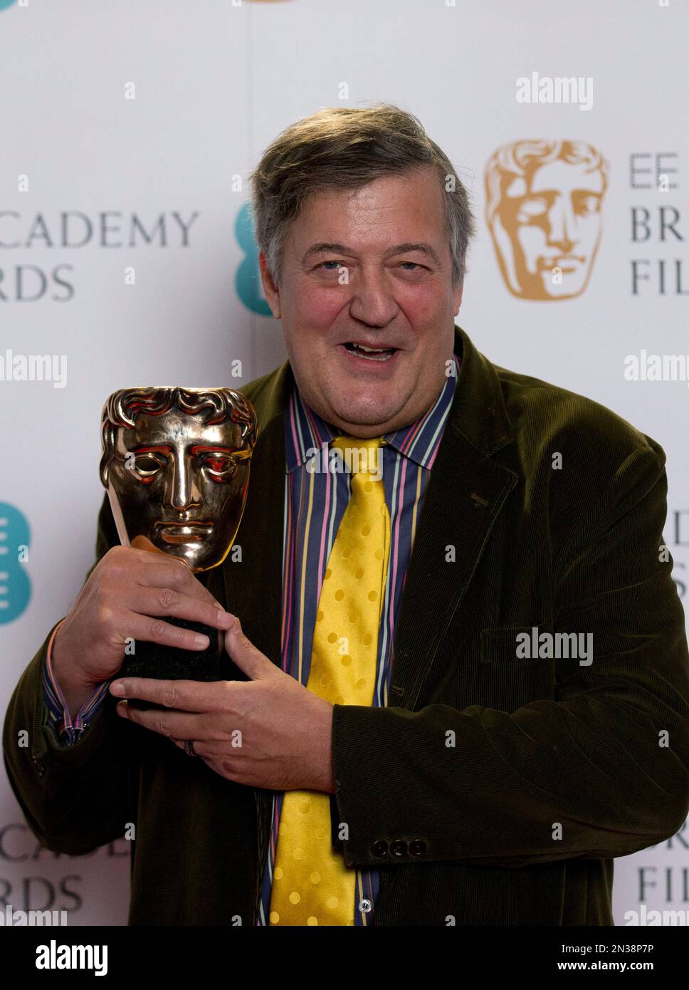 British comedian and actor Stephen Fry poses for photographs with a ...