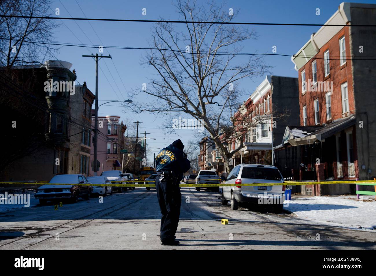 A member of the crime scene unit photographs evidence Thursday, Jan. 8 ...