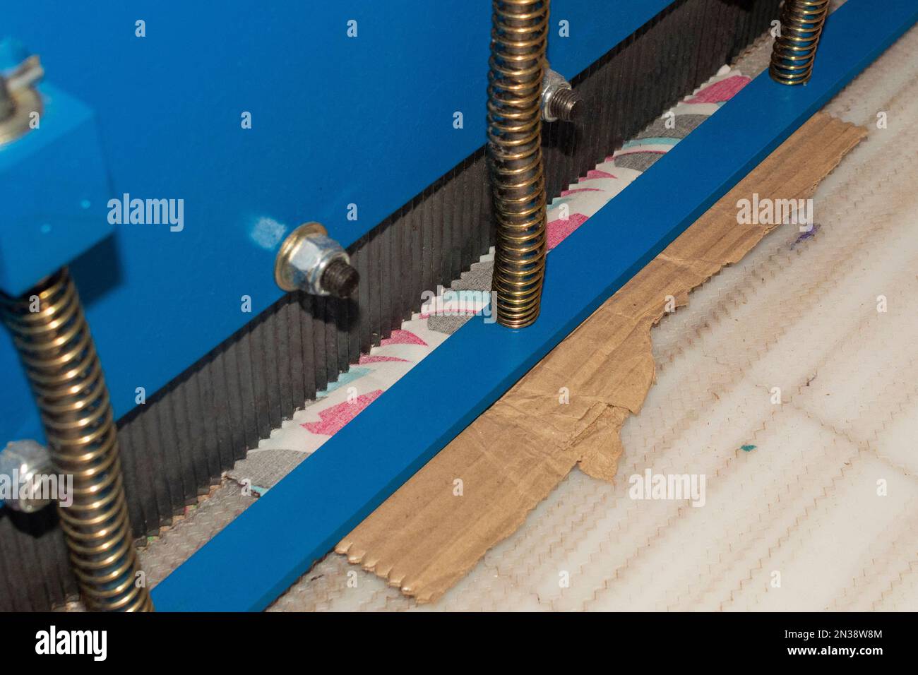 Close up to a blue cutting cloth machine Stock Photo - Alamy