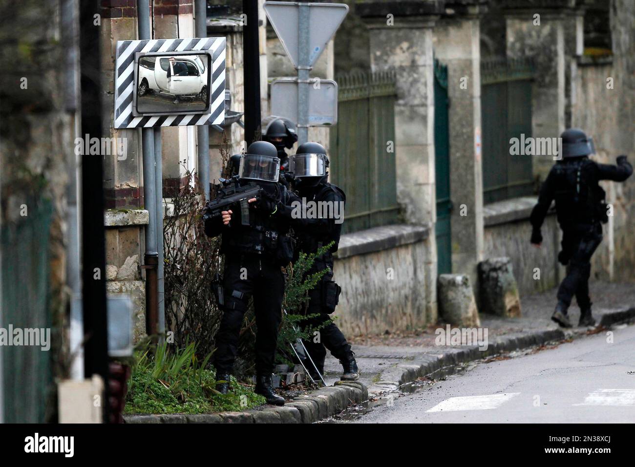 SWAT police officers patrol in the village of Longpont, northeast of ...