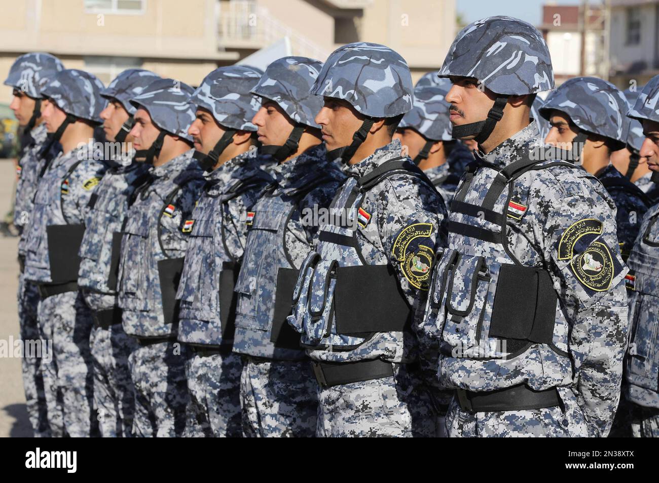 Iraqi policemen stand in formation in a parade marking Police Day in ...
