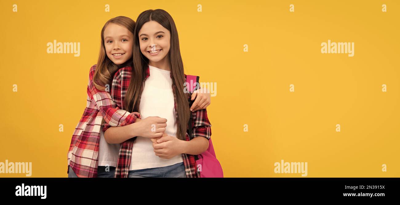 School girls friends. knowledge day. concept of education. kids with long hair on yellow ...