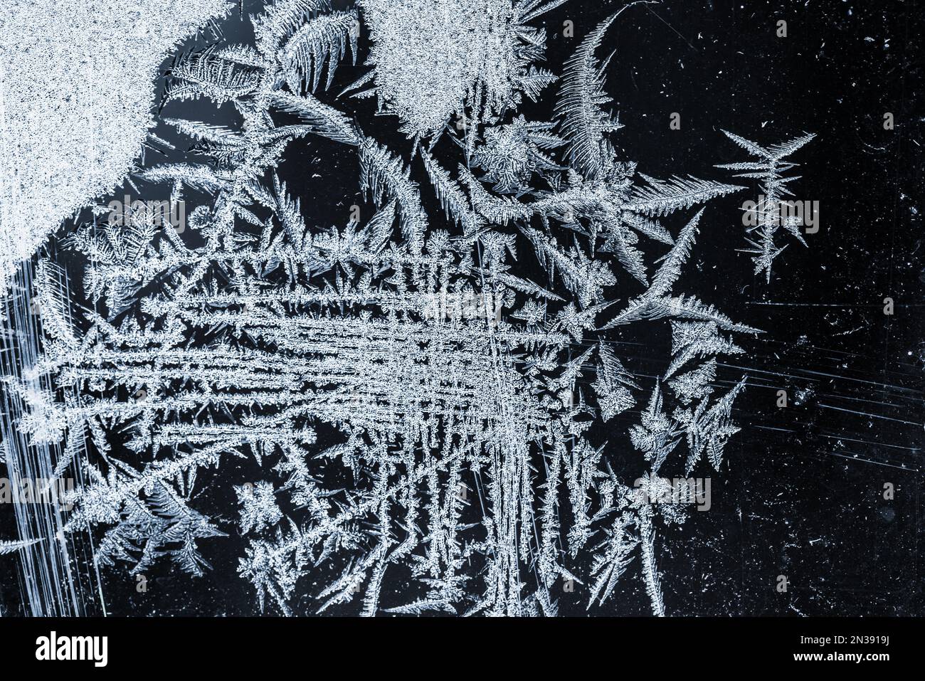 Frost pattern on dark window, natural winter background Stock Photo - Alamy
