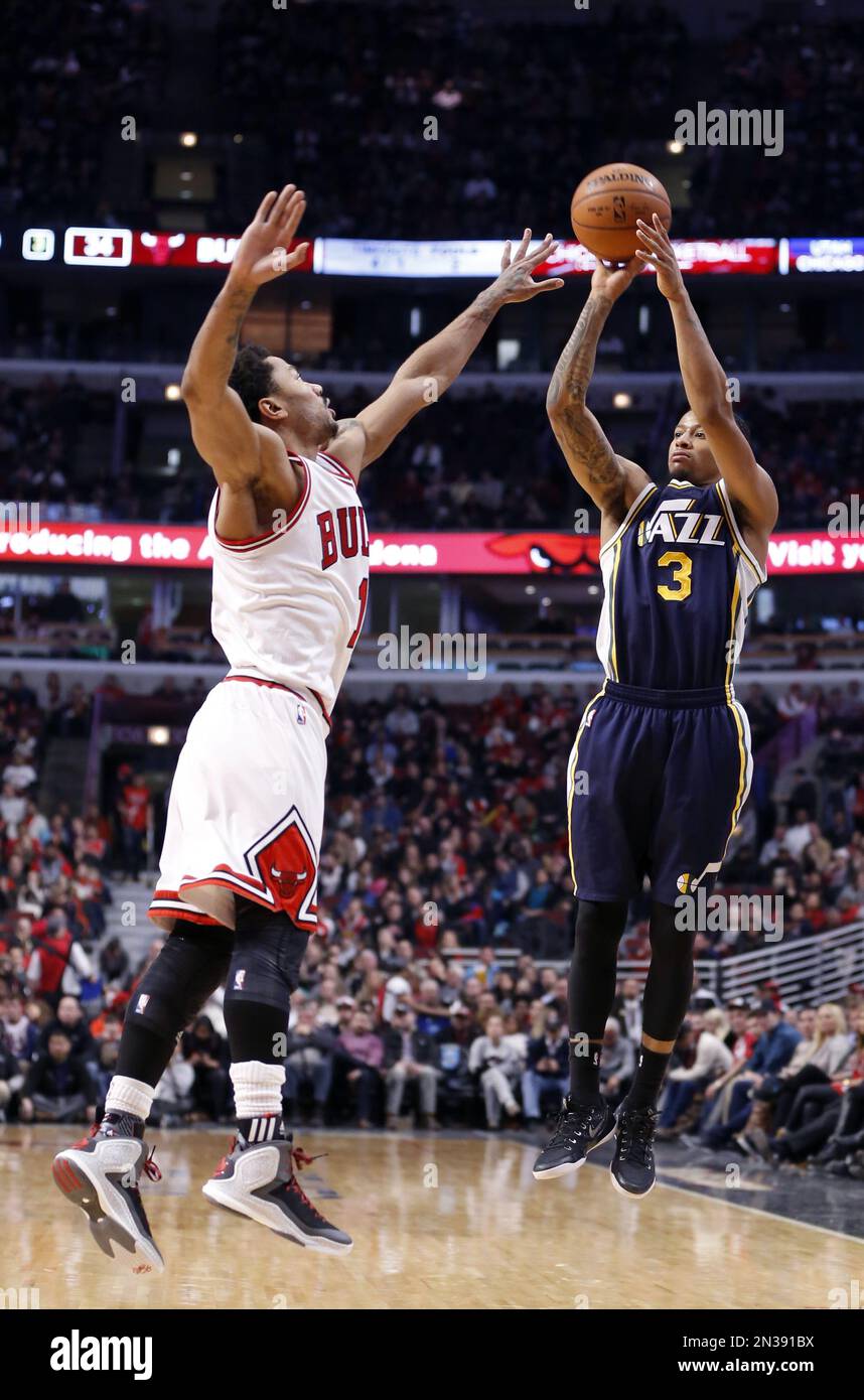 Utah Jazz guard Trey Burke (3) shoots over Chicago Bulls guard Derrick ...