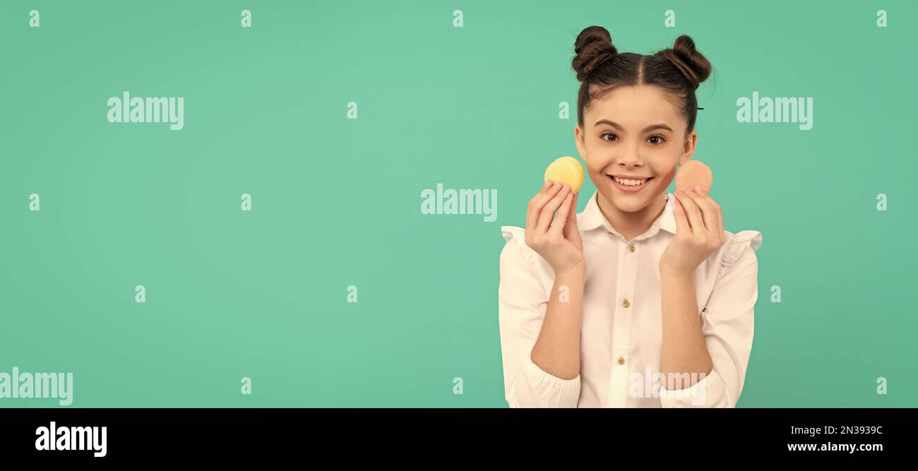 smiling child in school uniform with macaron on blue background ...