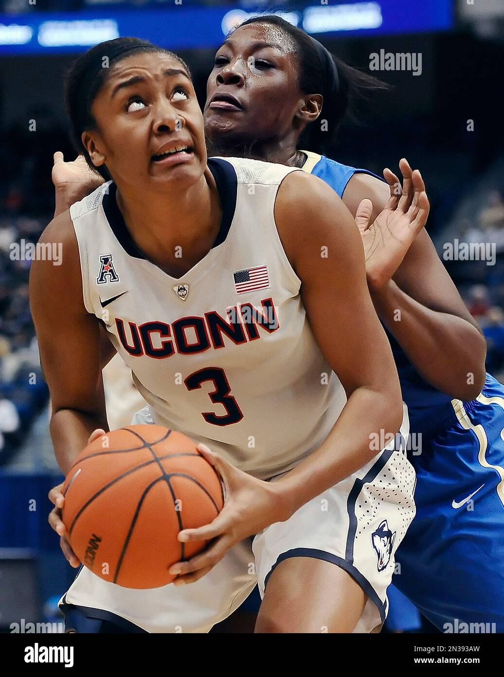 Connecticut’s Morgan Tuck, left, looks up to the basket as Tulsa’s ...