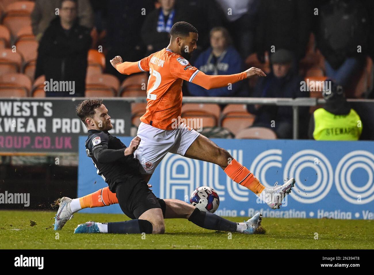 CJ Hamilton #22 of Blackpool is tackled by Oliver Turton #2 of ...