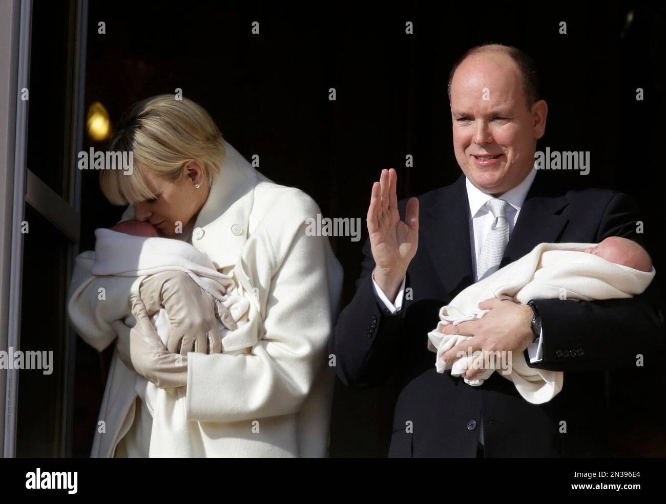 Princess Charlene and Prince Albert appear on a palace balcony, each ...