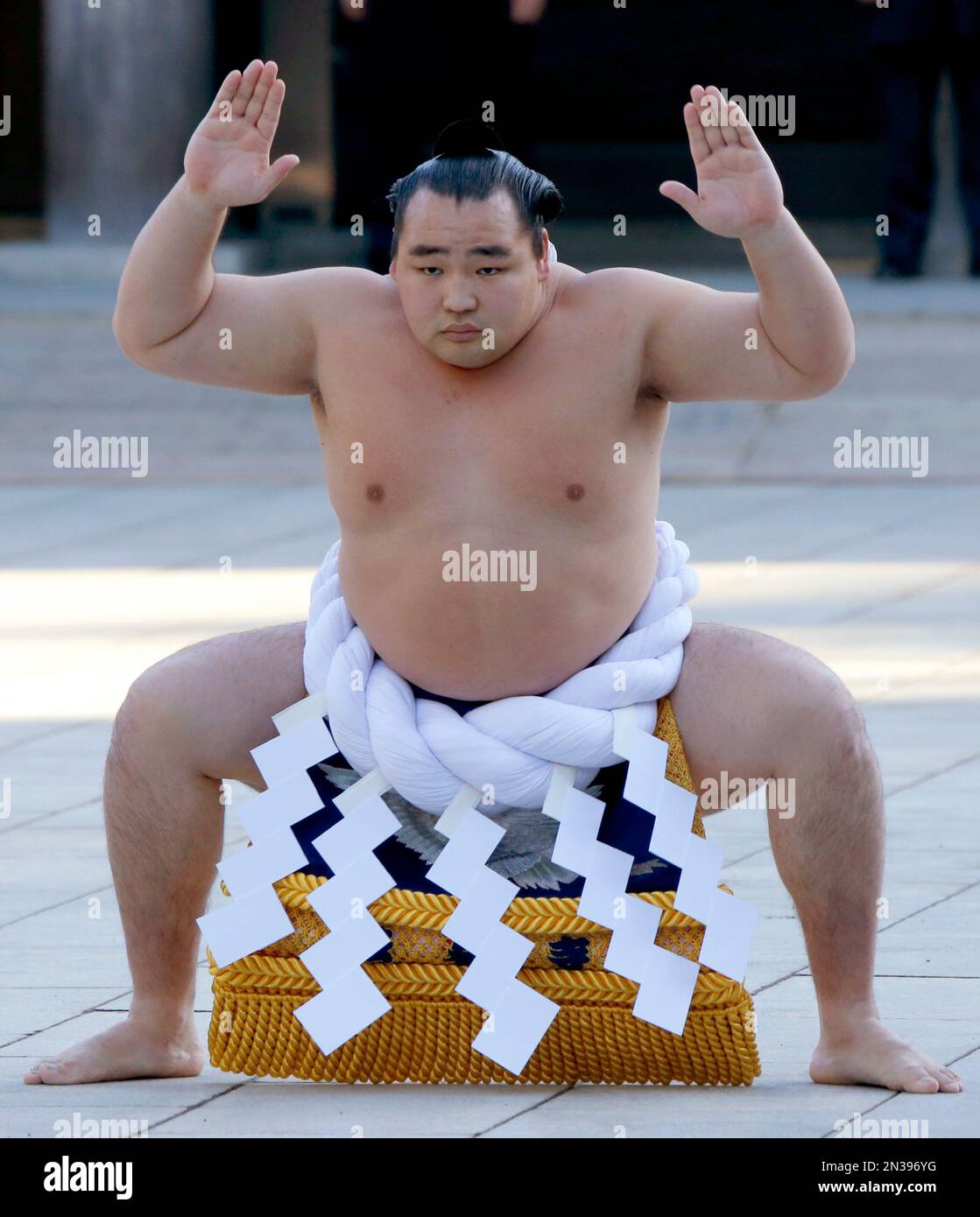 Sumo grand champion Kakuryu of Mongolia performs his ring entry forms ...