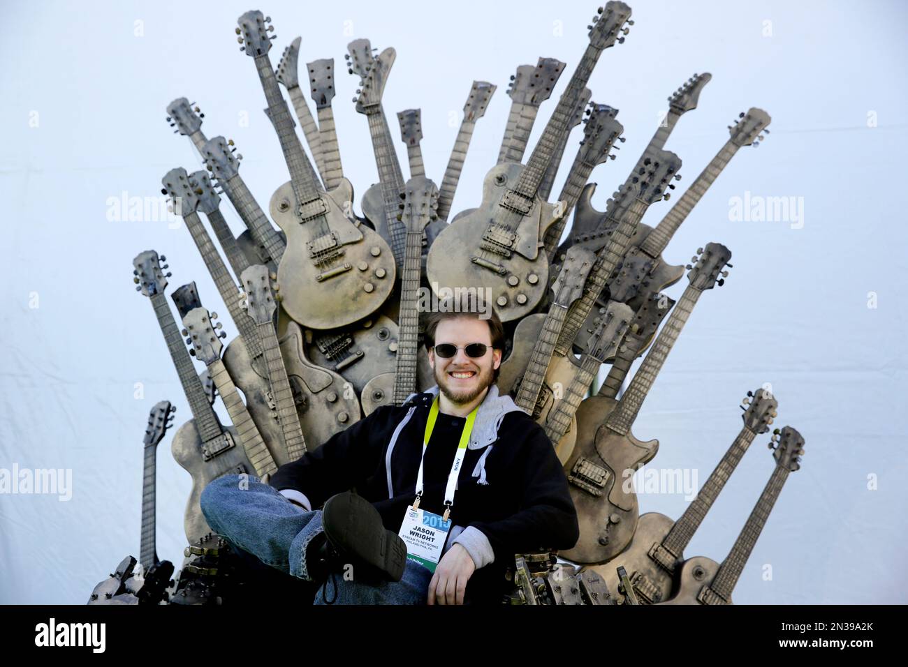 Jason Wright poses for photos in a chair made with guitars at the ...