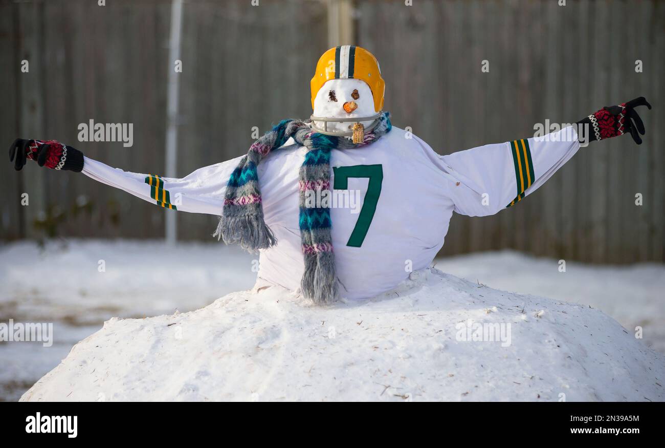 A Green Bay Packers snowman stands in a snow bank near Lambeau Field in ...