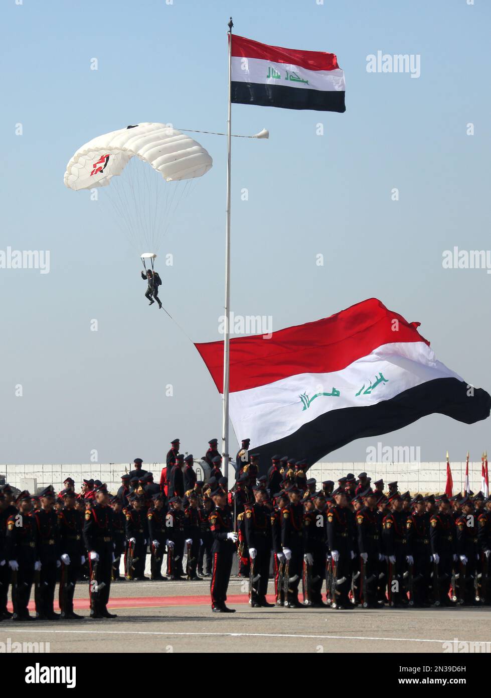 A member of Iraq's national skydiving team prepares to land with the ...