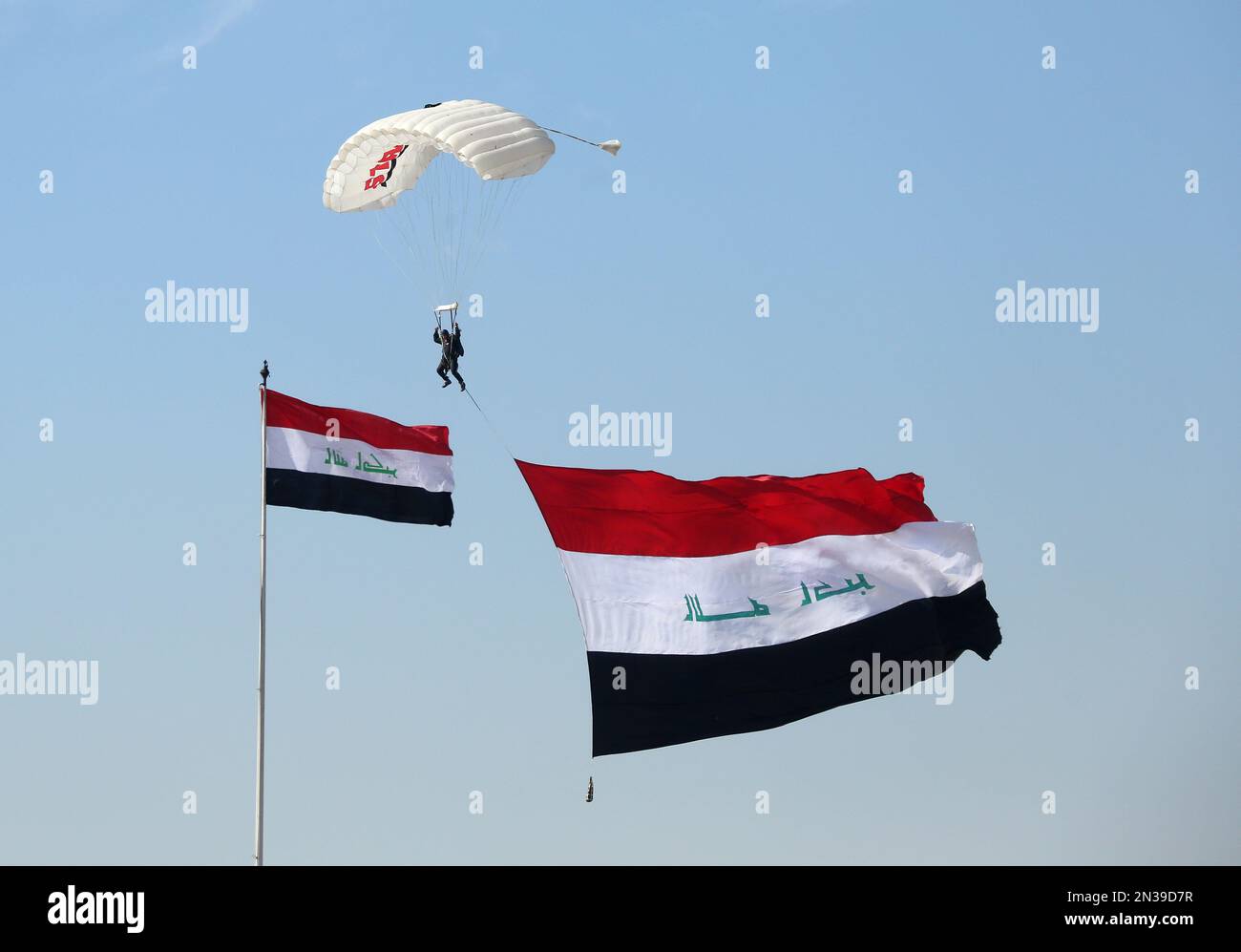 A member of Iraq's national skydiving team, repares to land with the ...